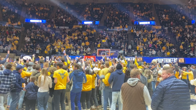 WVU Fans storm the court after win over Kansas